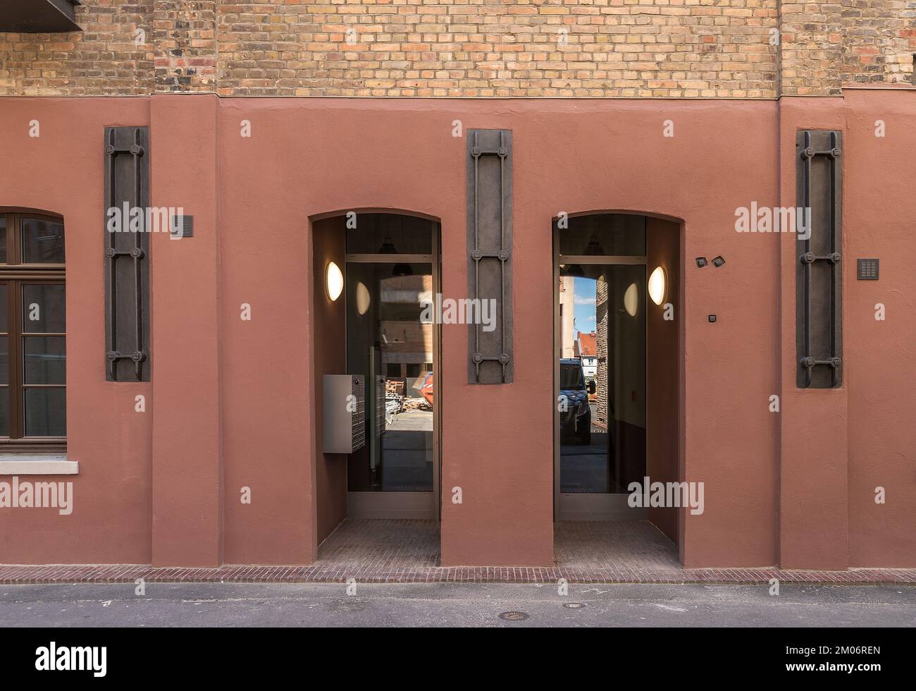 Restored entrance area of an old factory building Stock Photo - Alamy