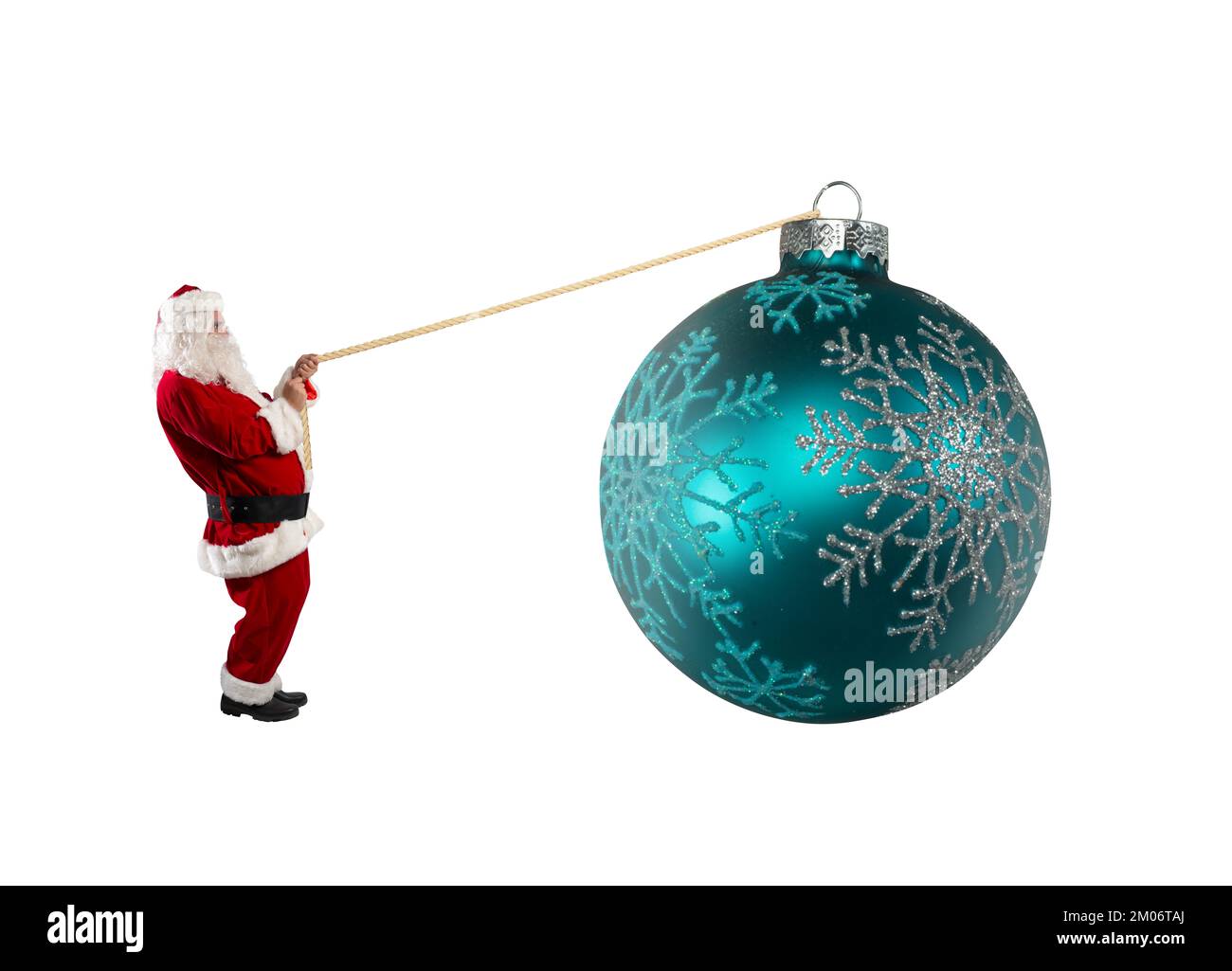 Santa claus pulls a rope to move a big christmas ball Stock Photo - Alamy