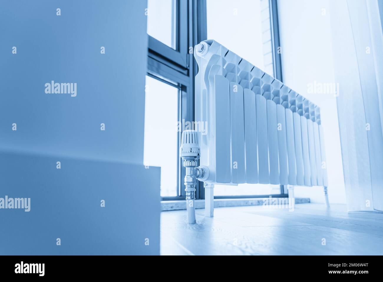White big radiator near window in modern room Stock Photo - Alamy