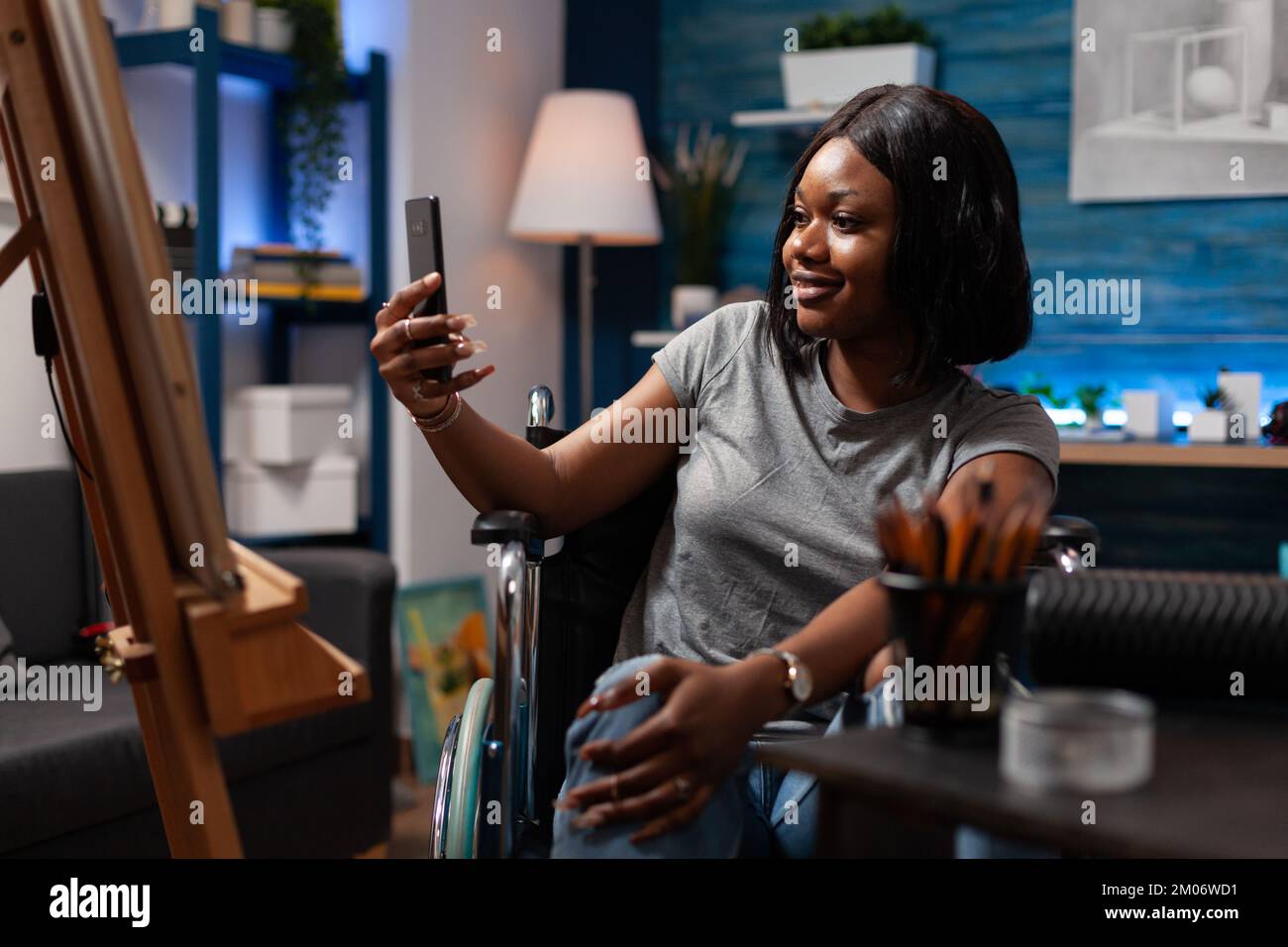 Young female artist sharing finished sketch masterpiece on social media ...