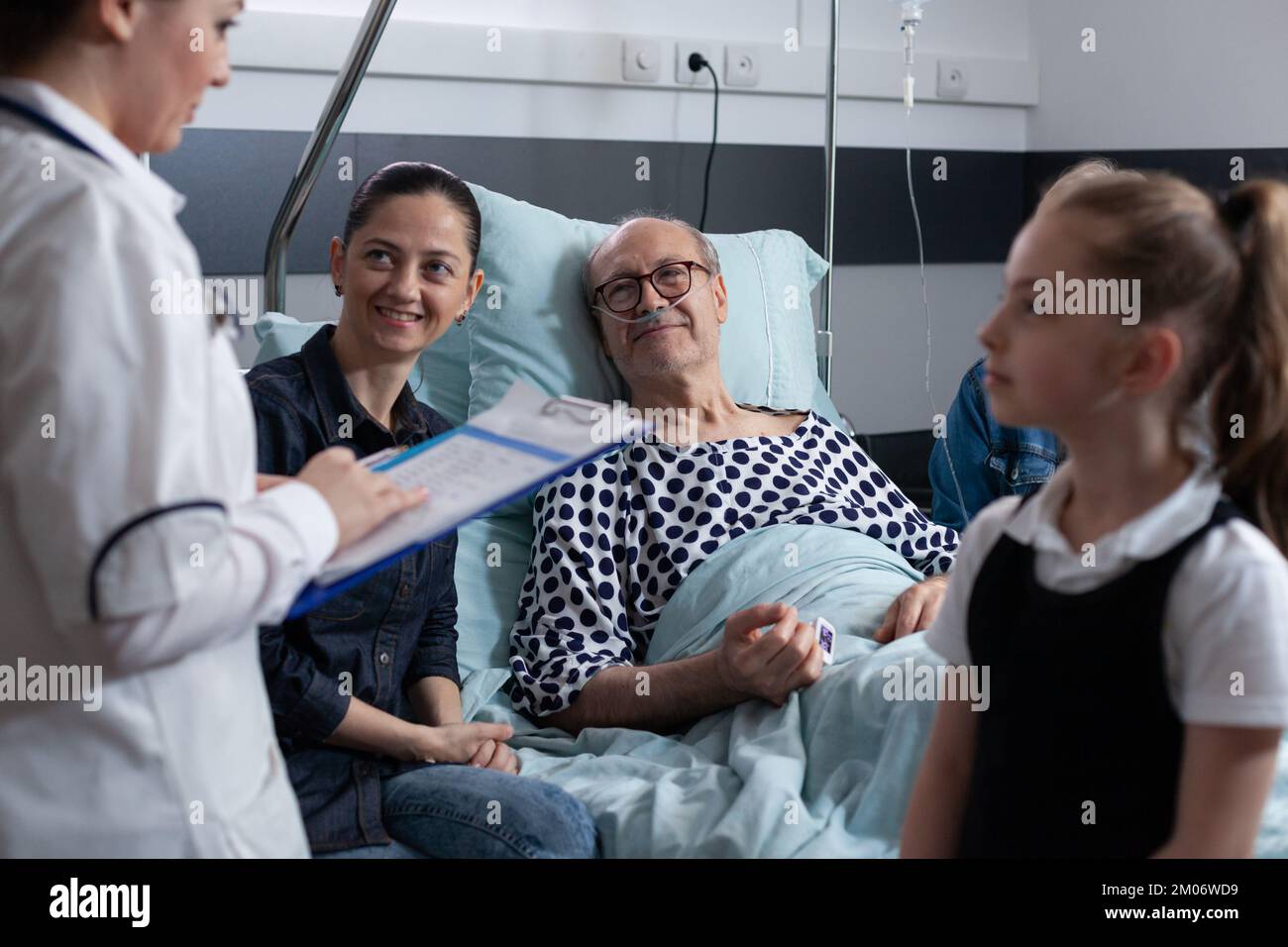 Geriatric physician delivering elderly sick man test results to family ...