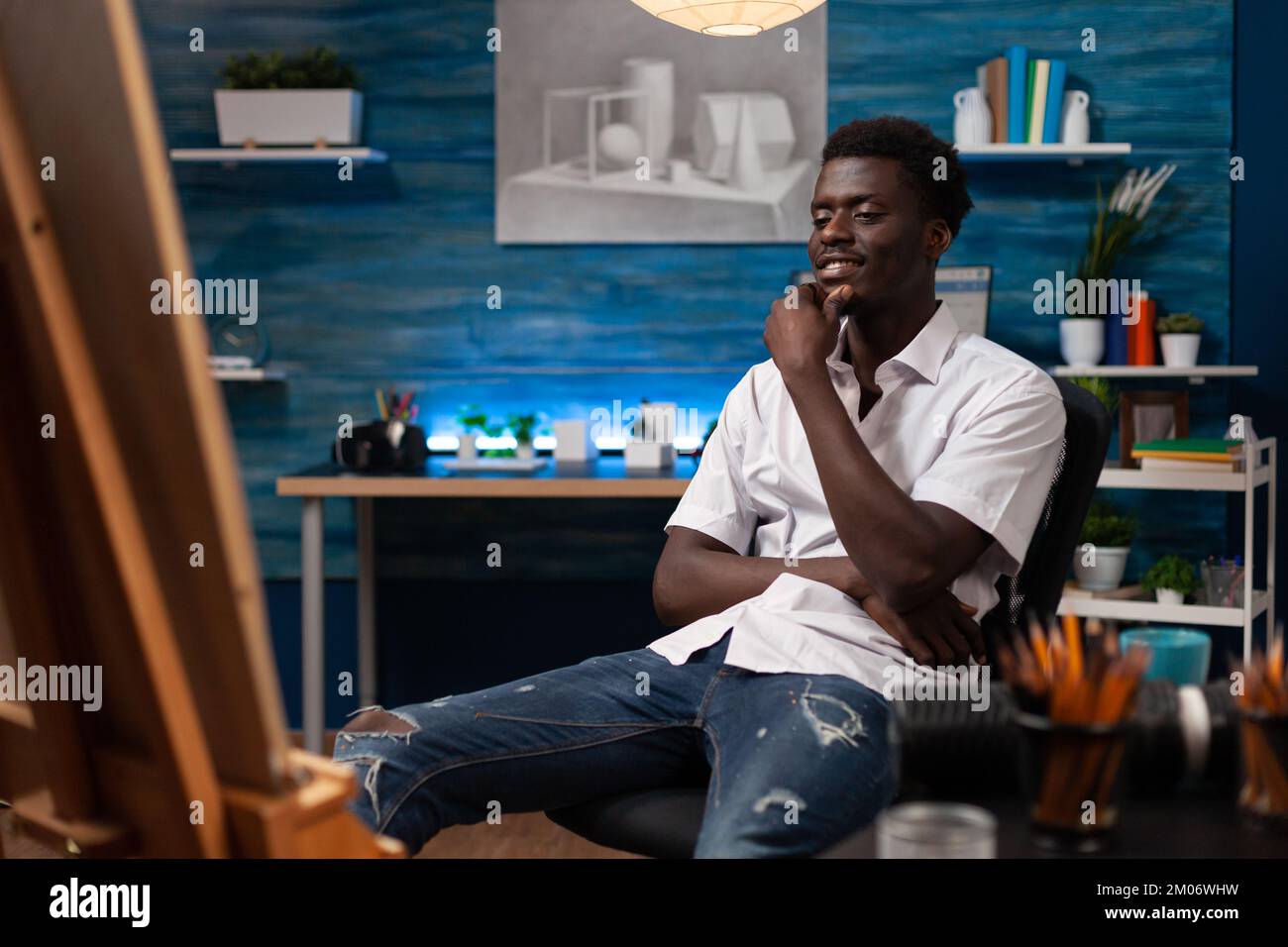 African american person with artistic interests smilingly looking at ...