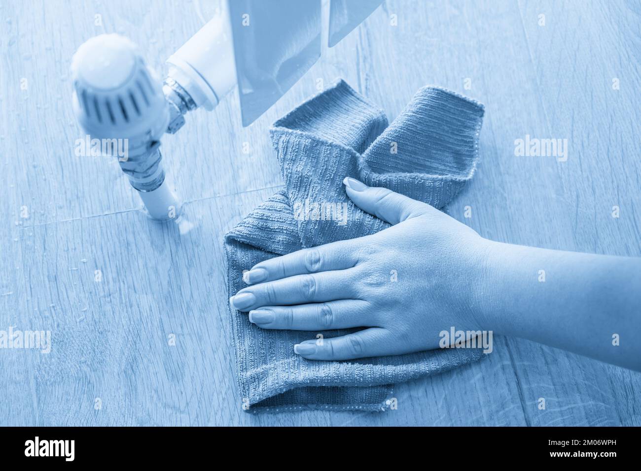 Female hand with rag cleaning water from heating radiator leak Stock ...