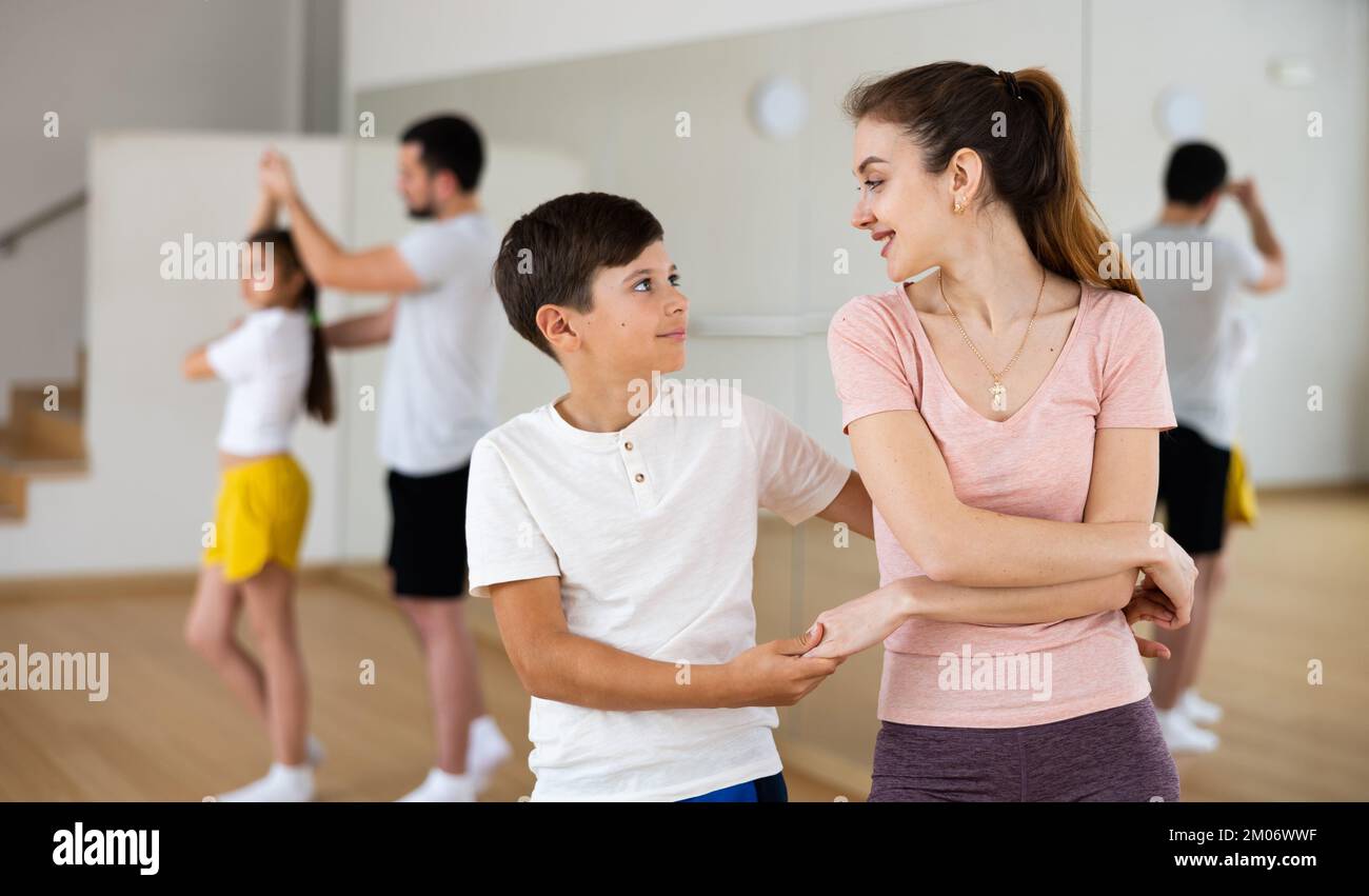 Tween boy enjoying active dance in pair with mother Stock Photo - Alamy