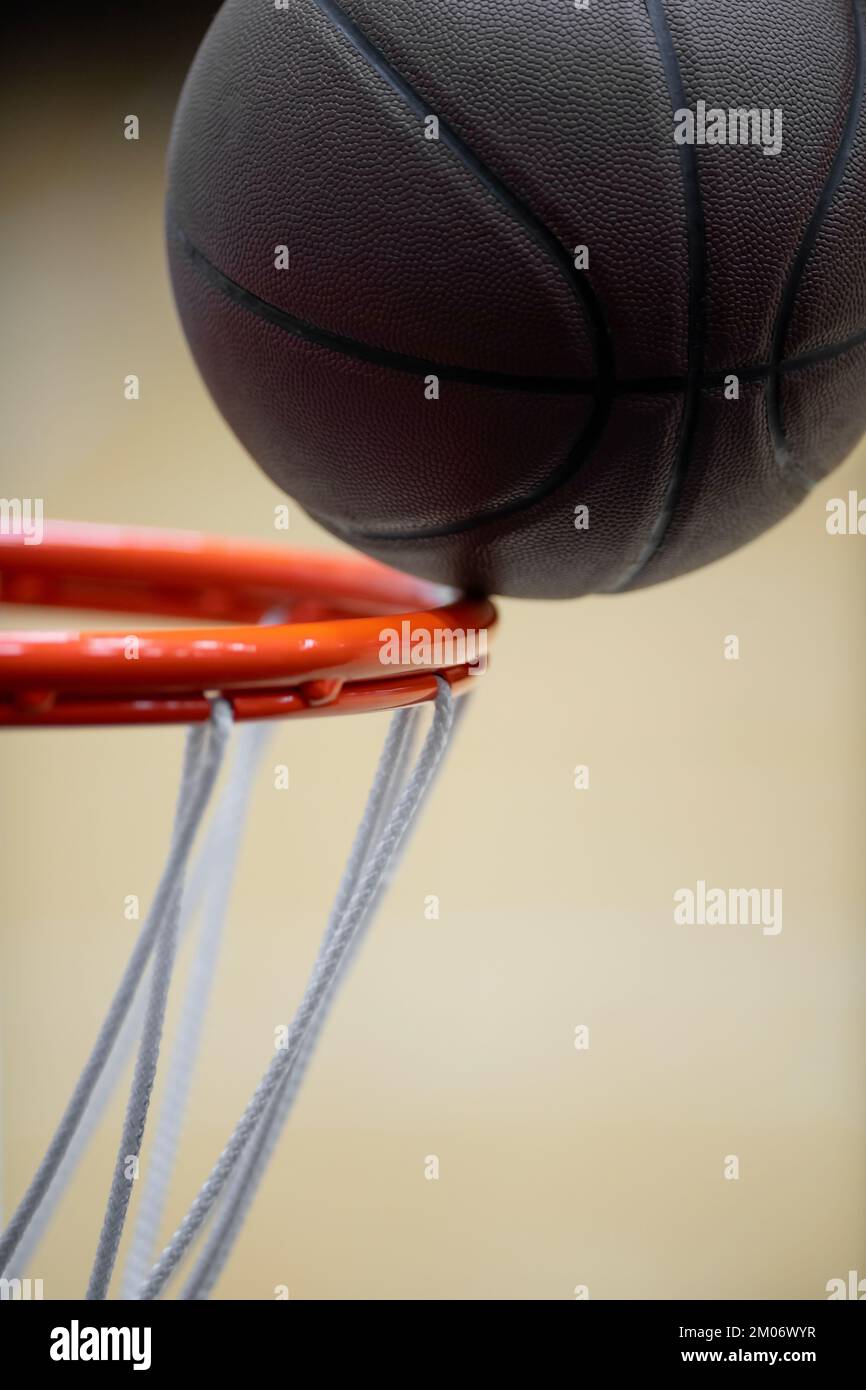 Brown basketball ball on orange hoop. Background for product display ...
