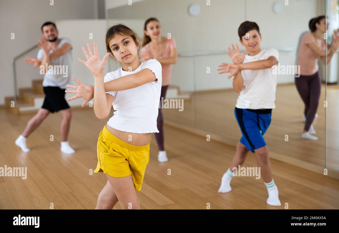 Girl exercising during family dance class Stock Photo - Alamy