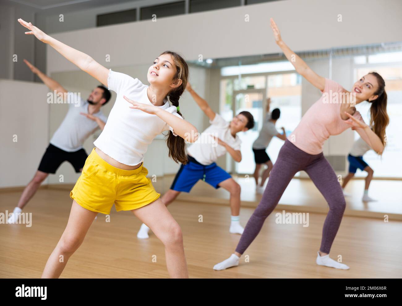 Girl exercising during family dance class Stock Photo - Alamy