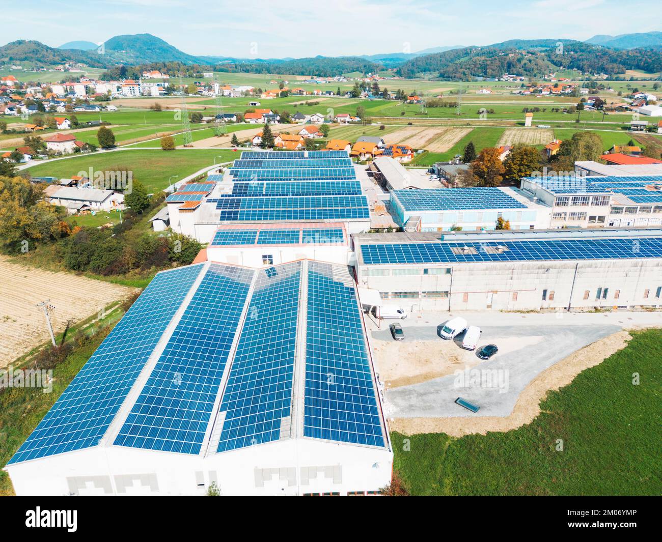 Solar panels installed across the roof of a warehouse in the country ...