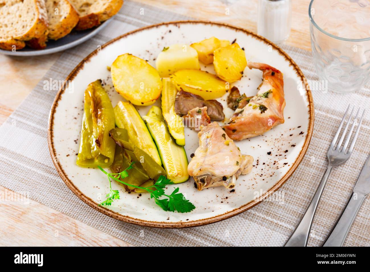 Roasted rabbit served with vegetable garnish Stock Photo - Alamy