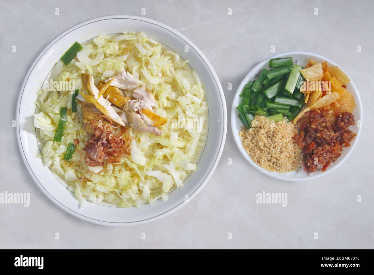 Soto Ayam (yellow chicken soup) with tempeh crackers is a popular ...