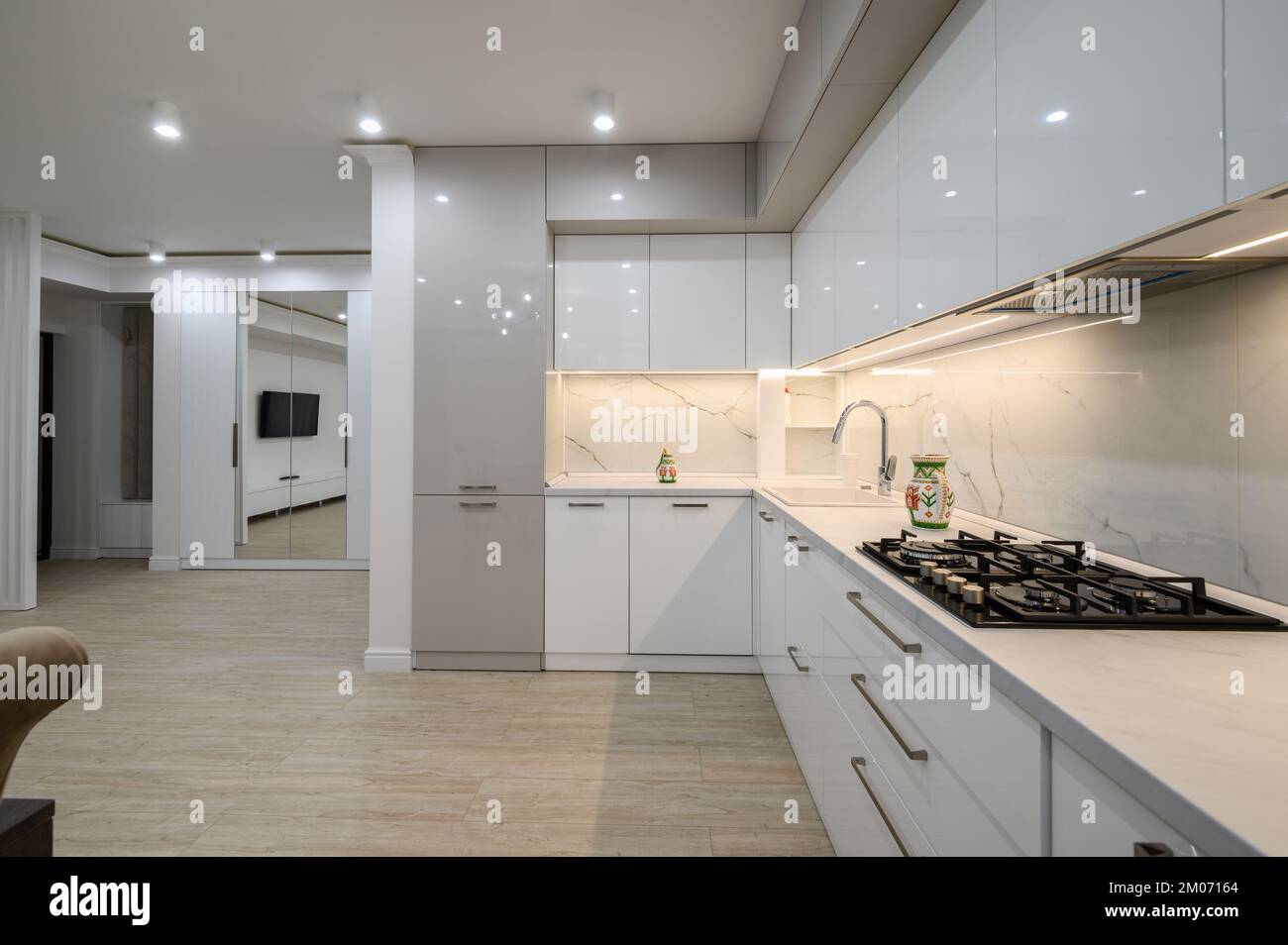 Huge white luxury kitchen in a studio apartment interior Stock Photo ...