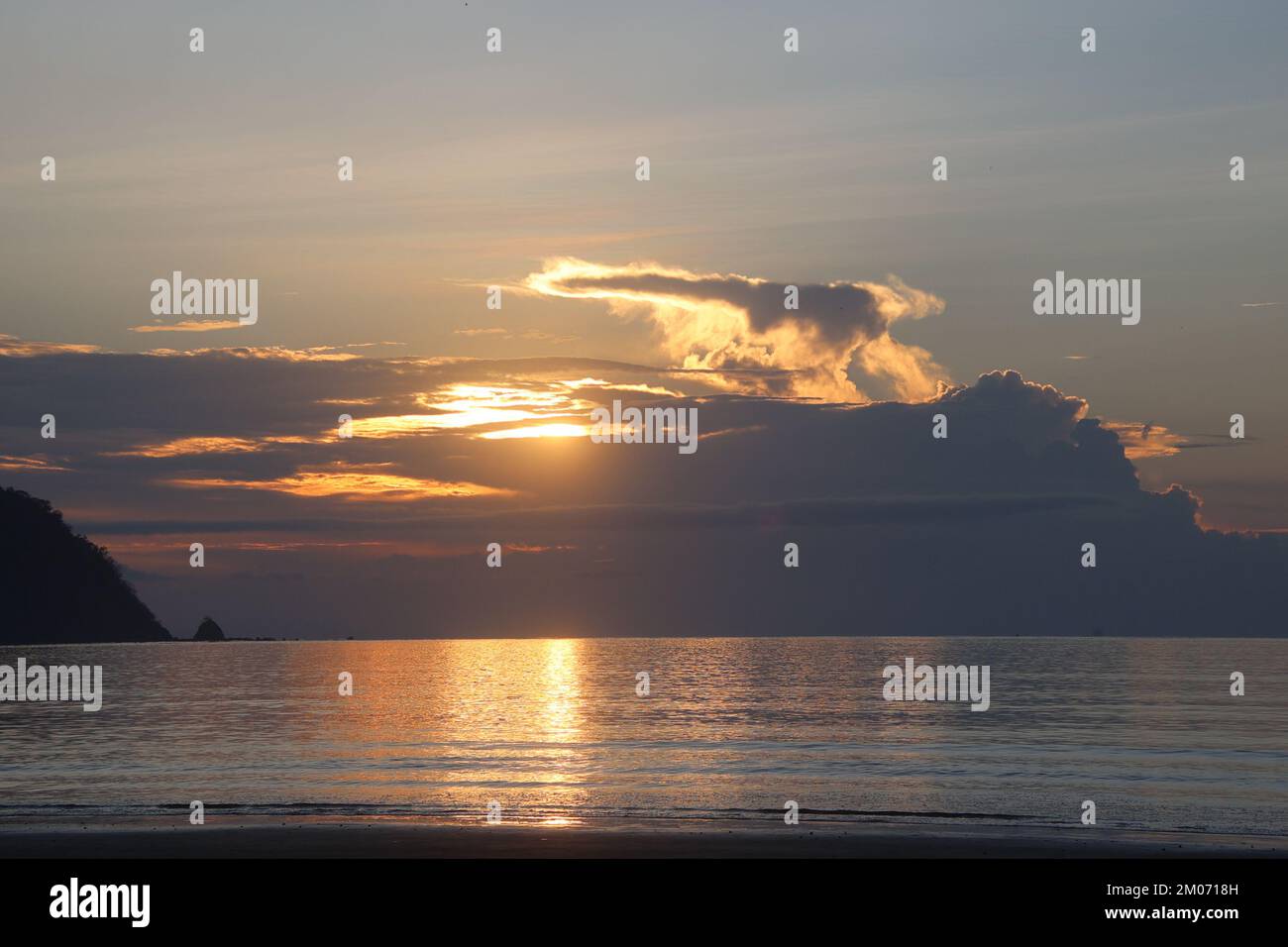 Sunset over the ocean between the clouds Stock Photo - Alamy