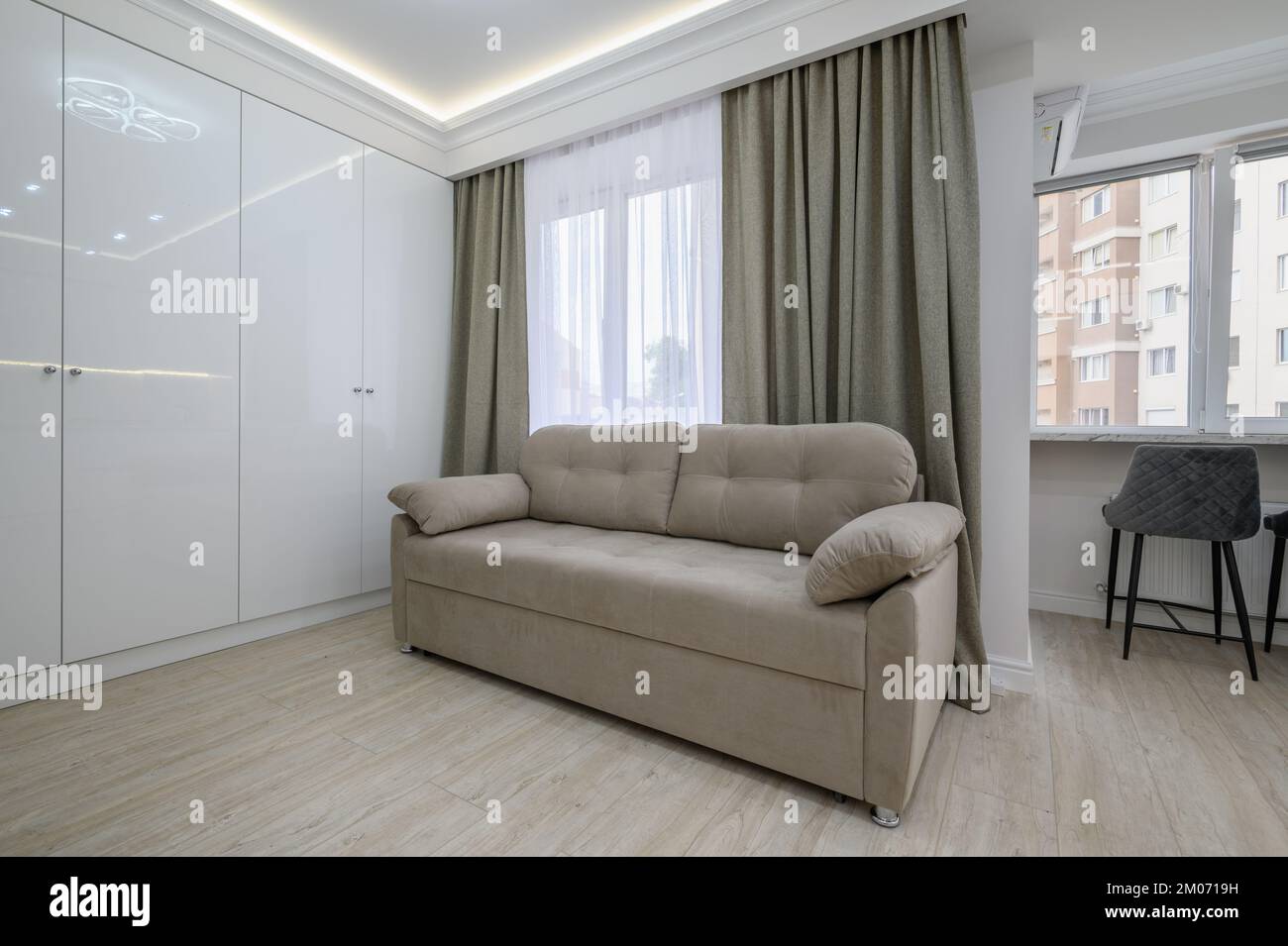 Small studio flat living room with a couch and a dining counter at ...