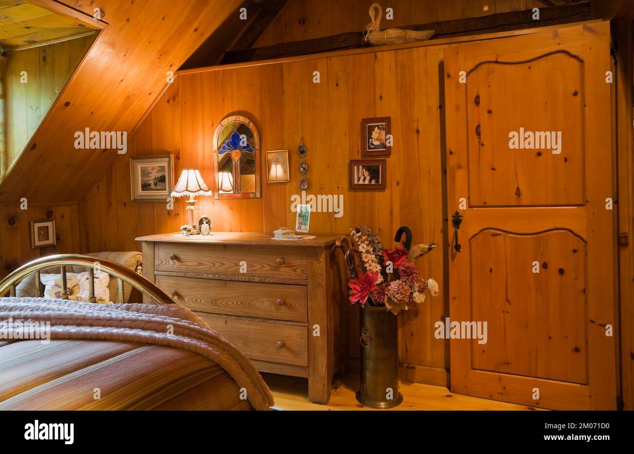 Brass bed and furnishings in guest room in attic inside old circa 1740 ...