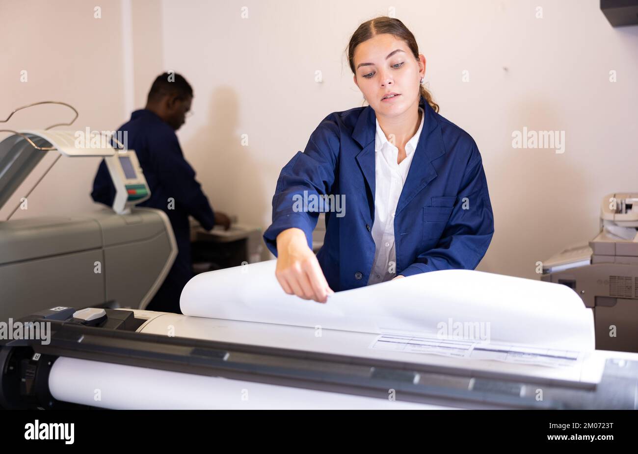 Female worker in a printing and press centar check print quality Stock ...