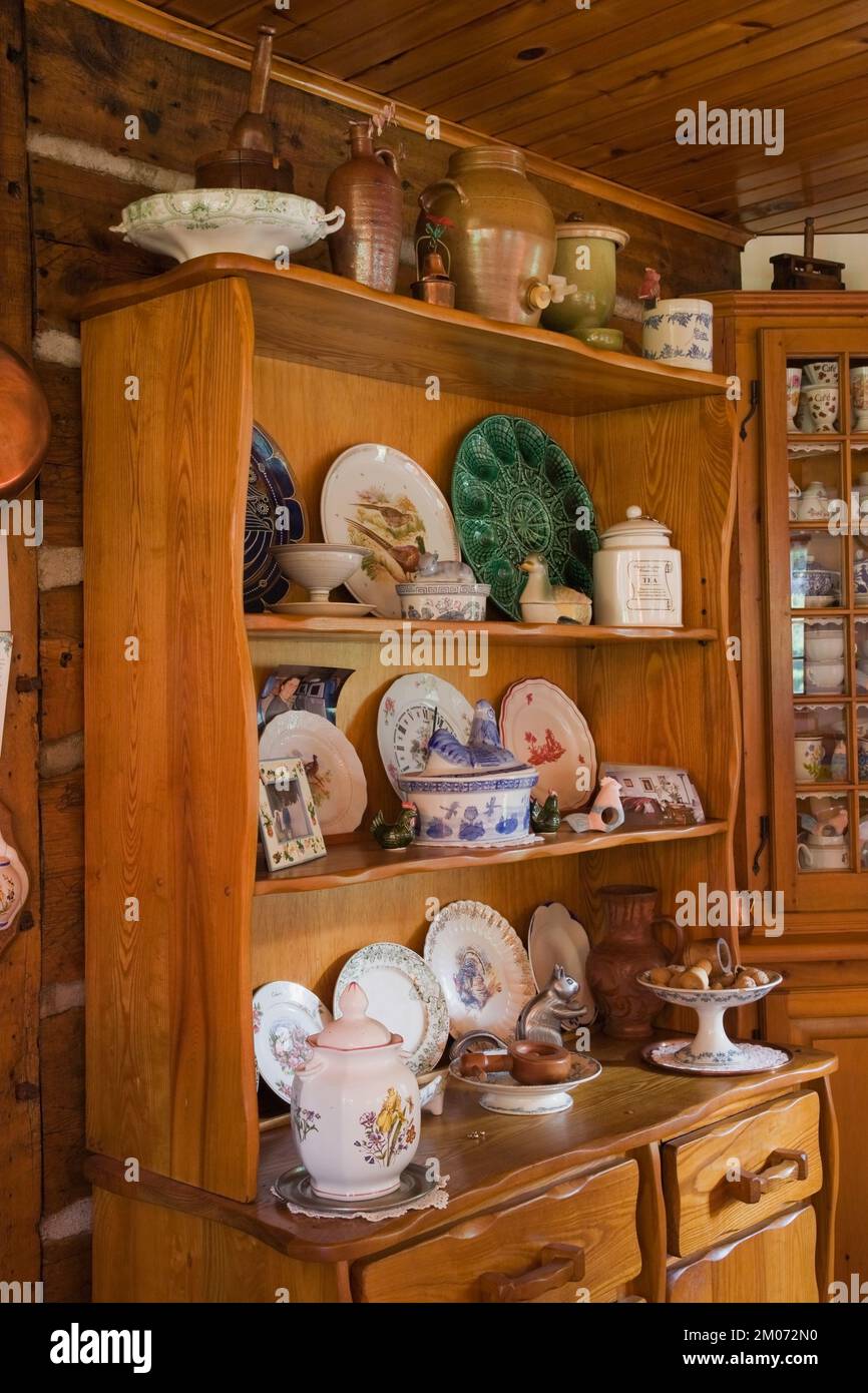 Antique buffet with chinaware in kitchen inside old 1800s reconstructed ...