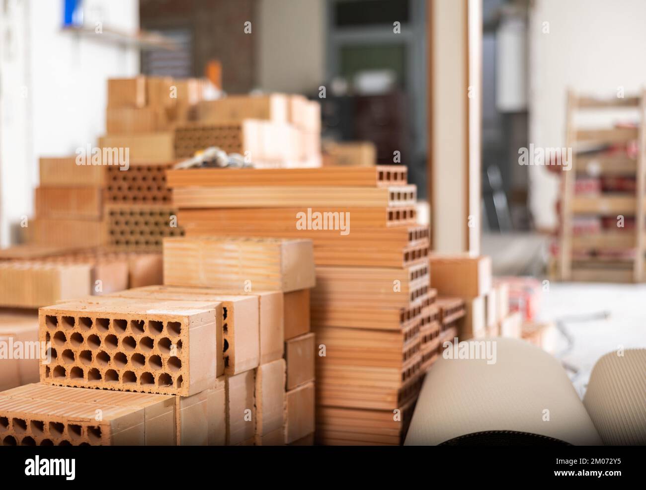 Stack of red bricks inside building under construction Stock Photo - Alamy