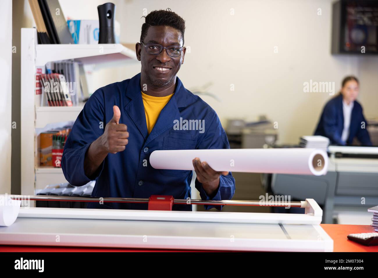 Portrait positive of man printshop worker with plotter paper roll Stock ...