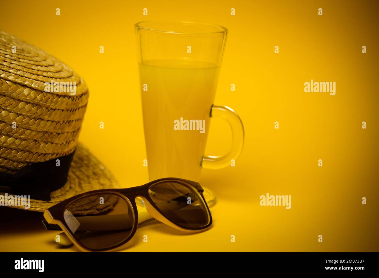 concept of relaxation and thirst on the beach. a glass of lemonade on a ...