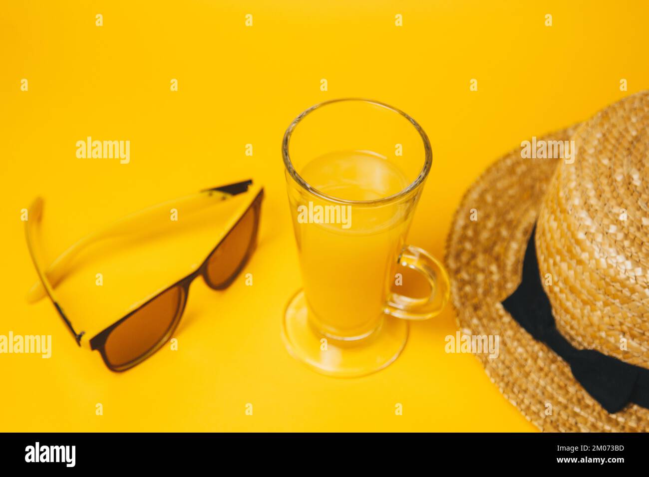 concept of relaxation and thirst on the beach. a glass of lemonade on a ...