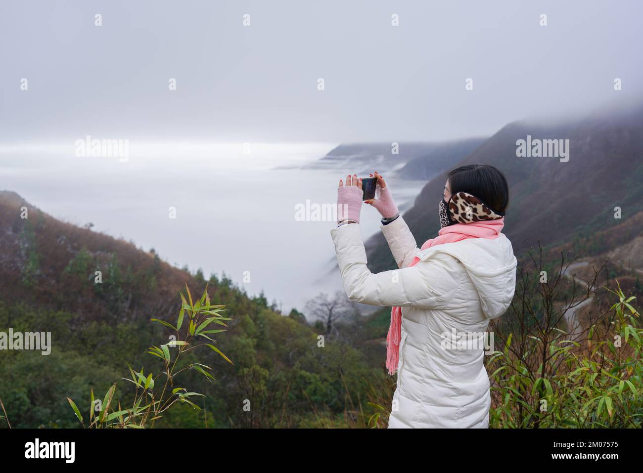 GUILIN, CHINA - DECEMBER 2, 2022 - A tourist takes photos of the sea of ...