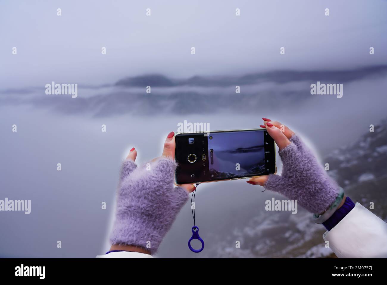 GUILIN, CHINA - DECEMBER 2, 2022 - A tourist takes photos of the sea of ...