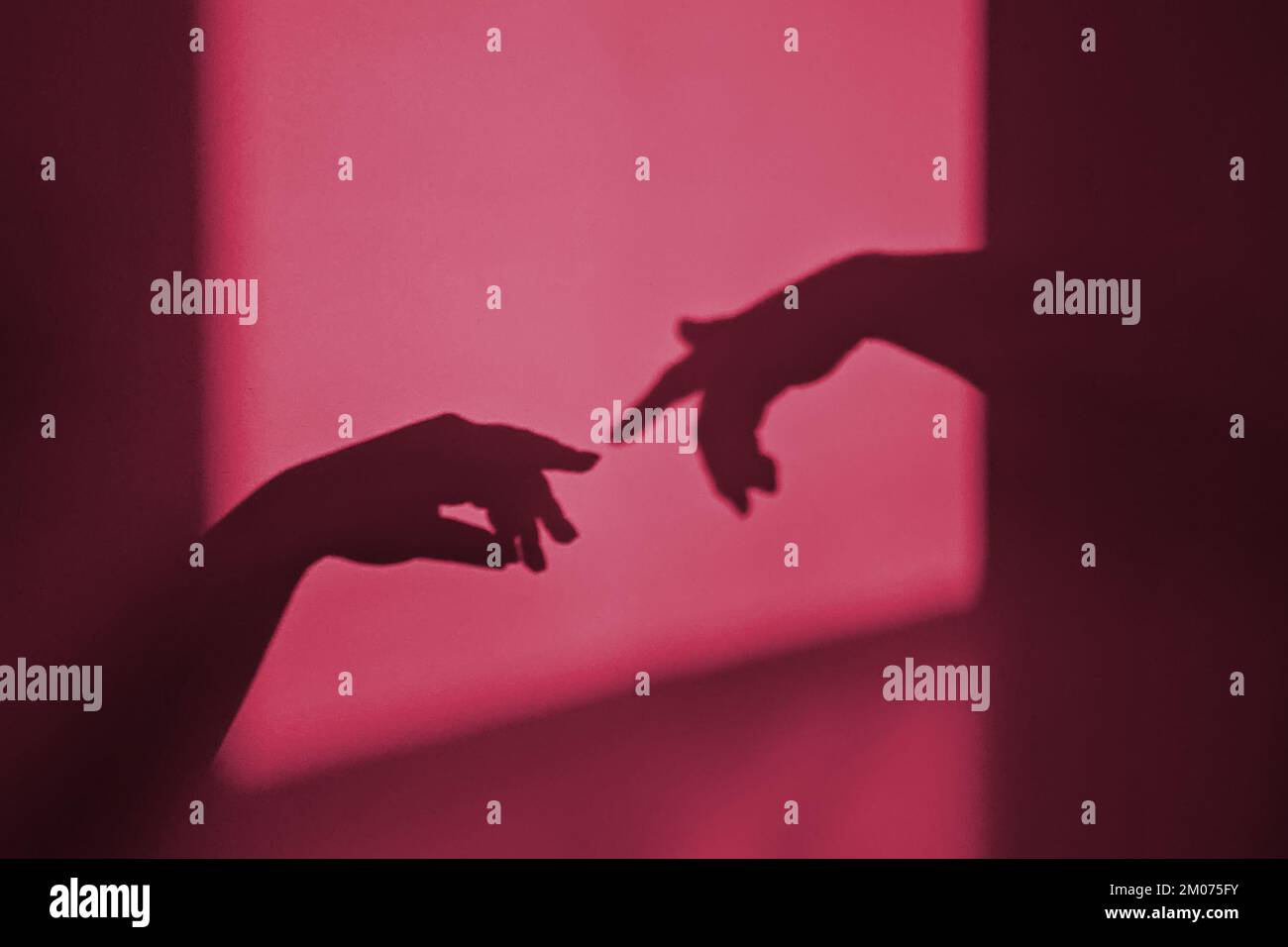 Shadow silhouette of gesture touch by humans palms from sunbeam on wall ...