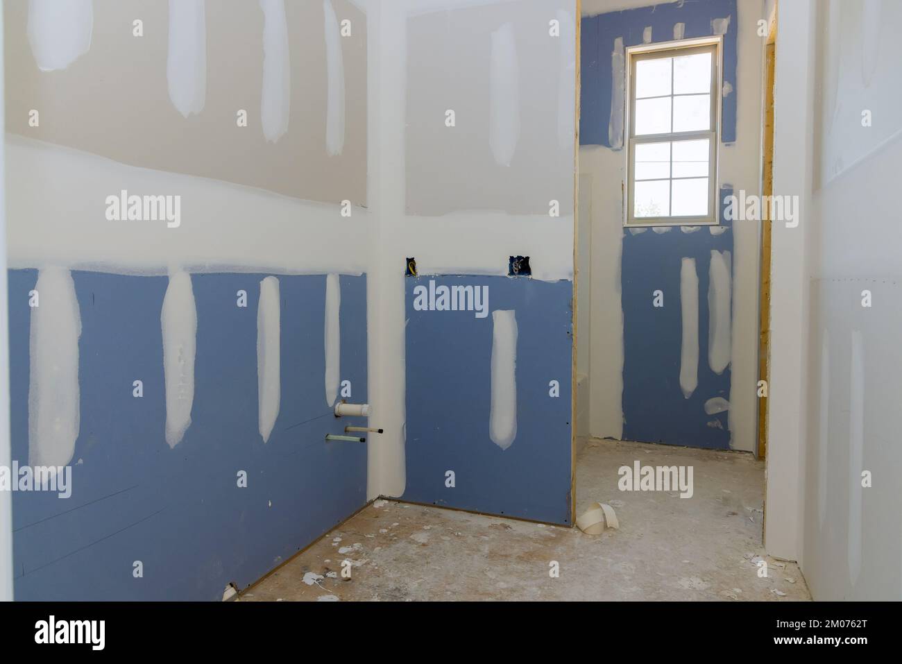 A newly constructed house in the process of being plastered drywall is ...