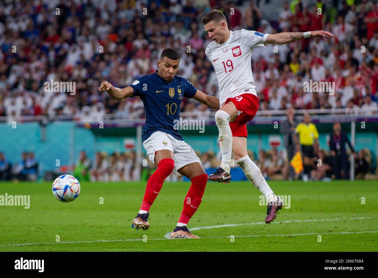 Kylian MBAPPE of France and Sebastian Szymanski of Poland during the ...