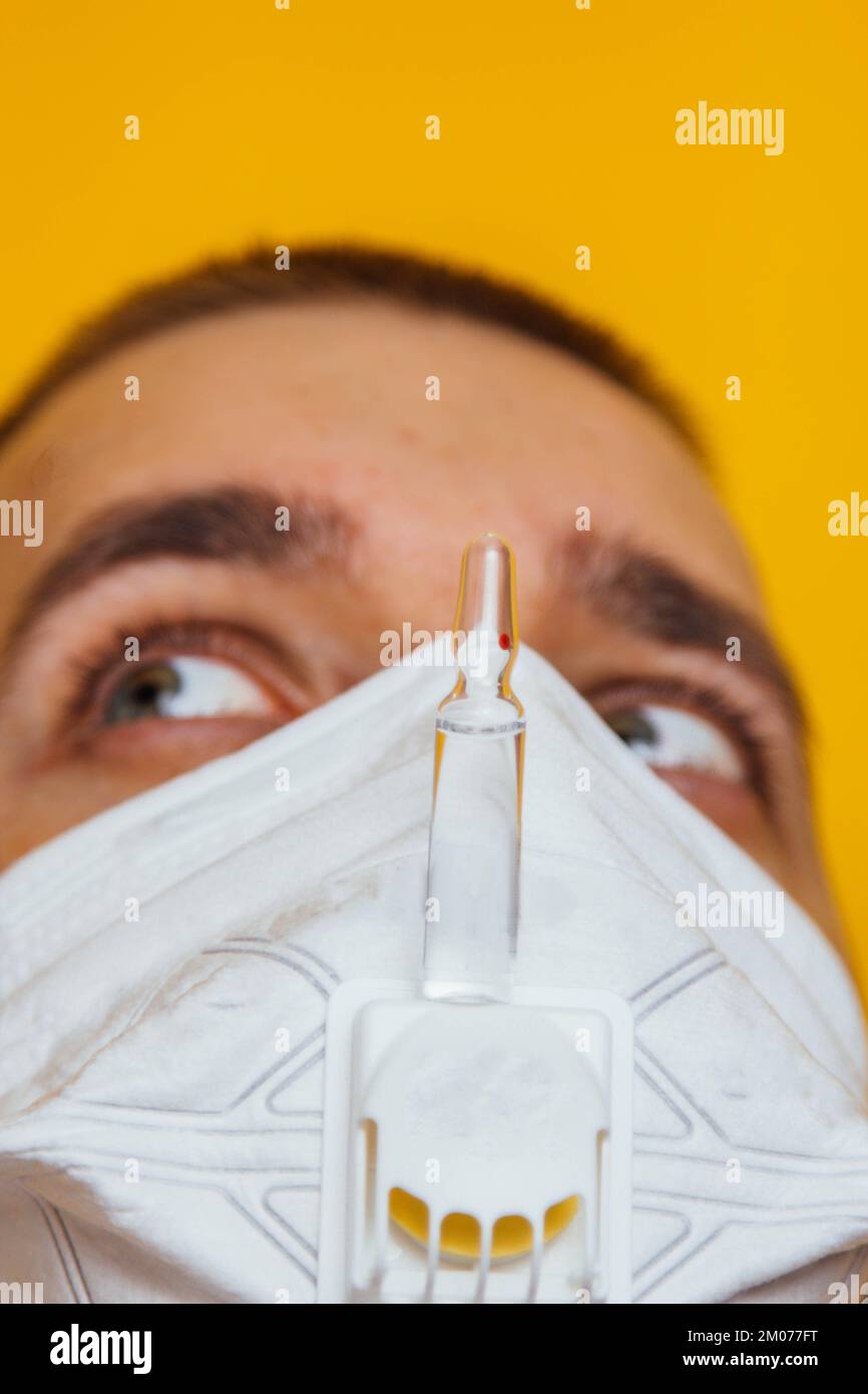 scared in medical mask looks in camera. Scared man in fear of ...