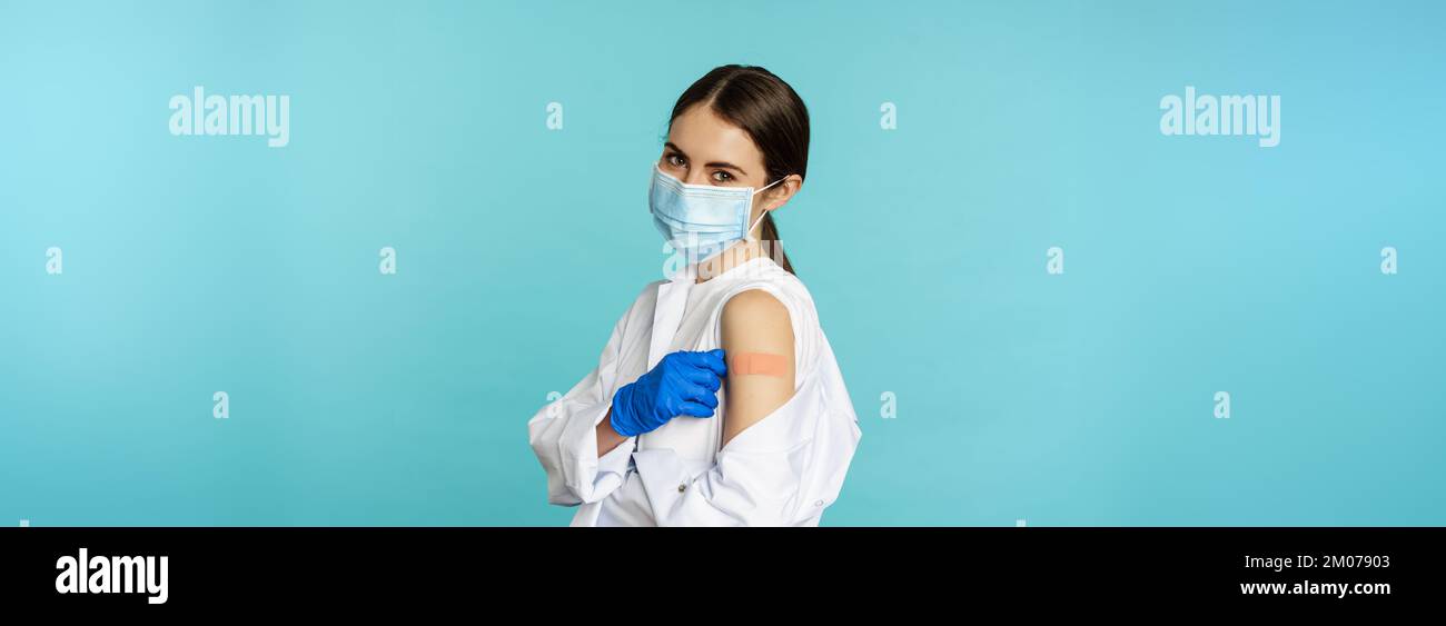 Young female doctor, nurse in medical face mask and hospital uniform ...
