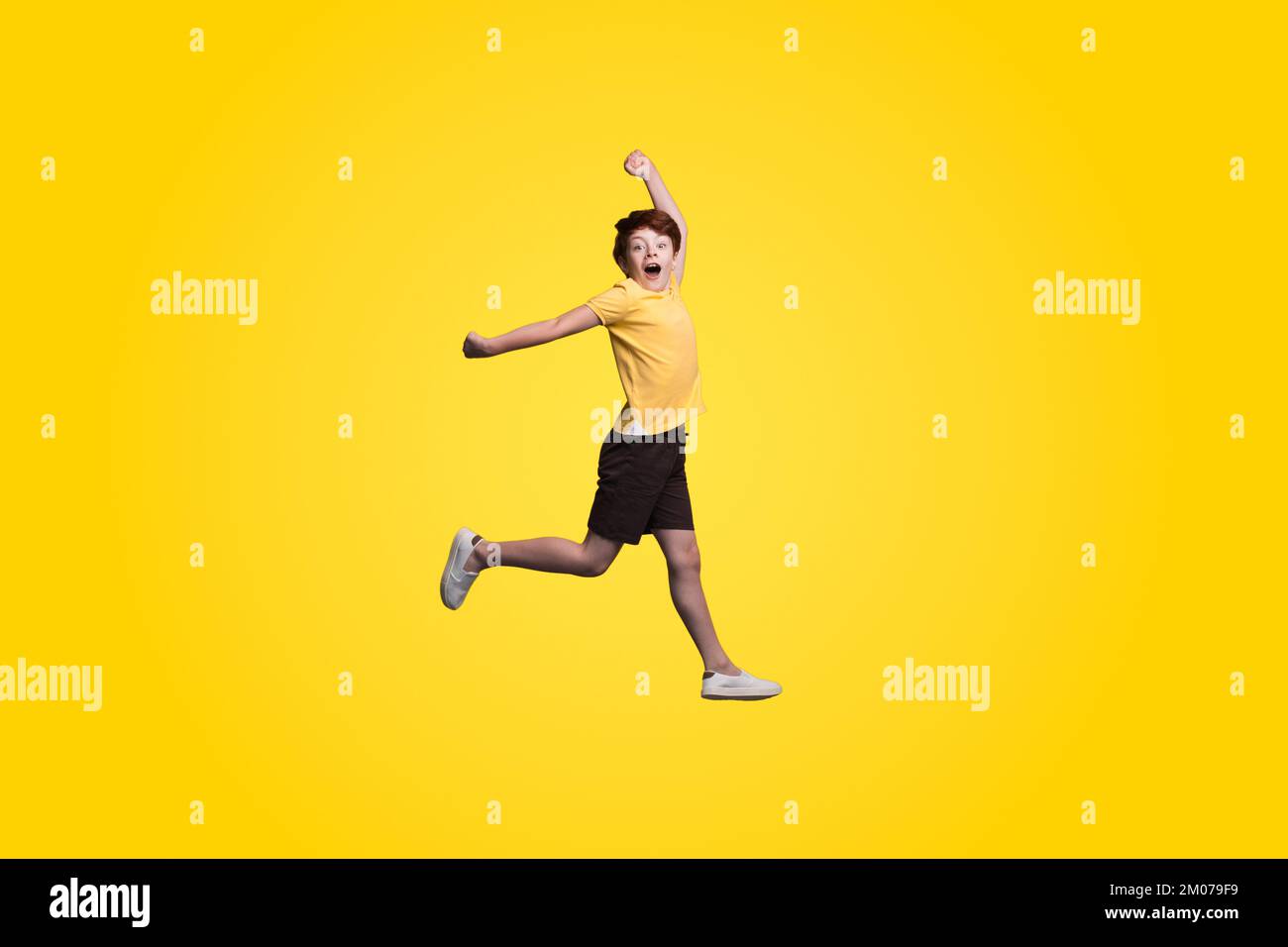 Joyful and happy boy expresses his emotions in a jump isolated on a ...