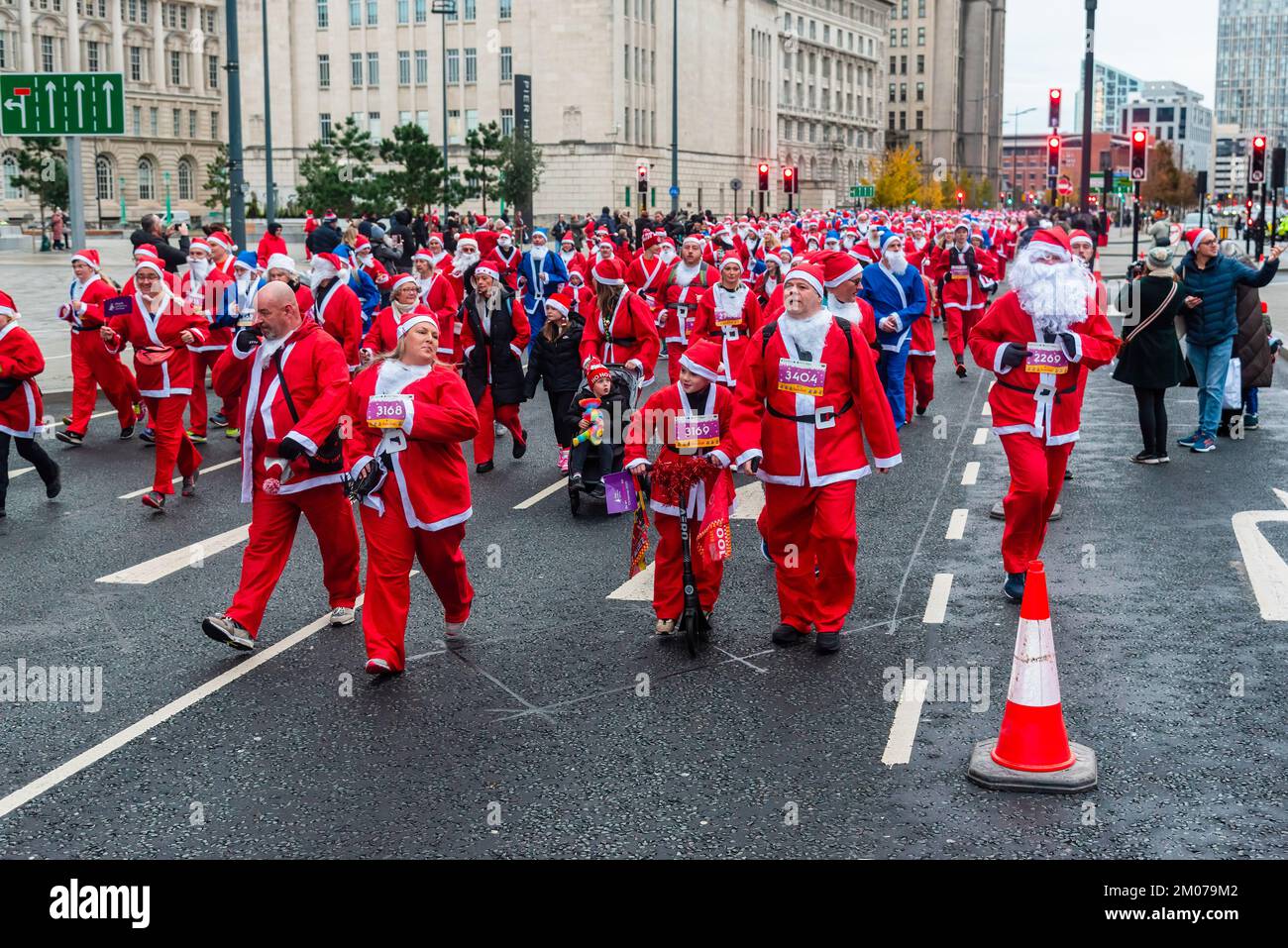 Runners race during the annual Liverpool Santa Dash. Thousands of ...