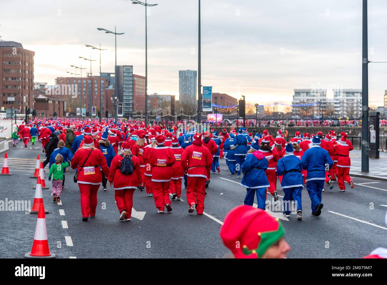 Runners race during the annual Liverpool Santa Dash. Thousands of ...