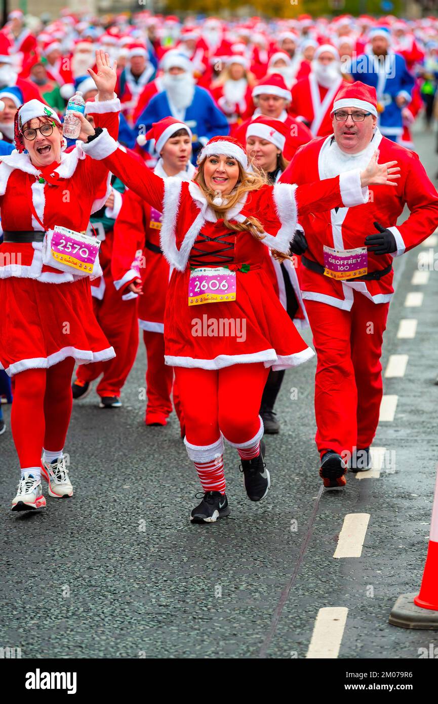 Runners race during the annual Liverpool Santa Dash. Thousands of ...