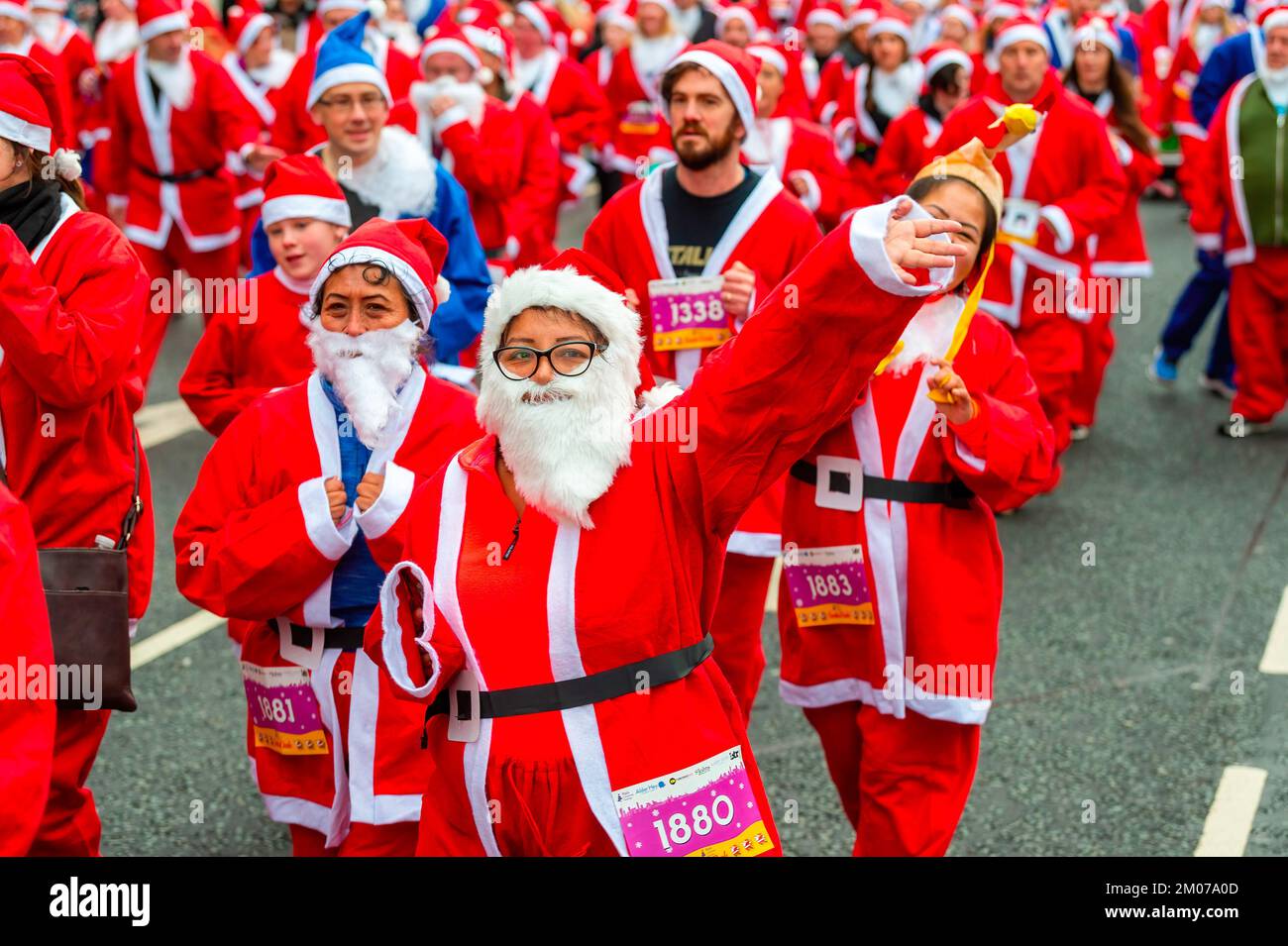 Runners race during the annual Liverpool Santa Dash. Thousands of ...