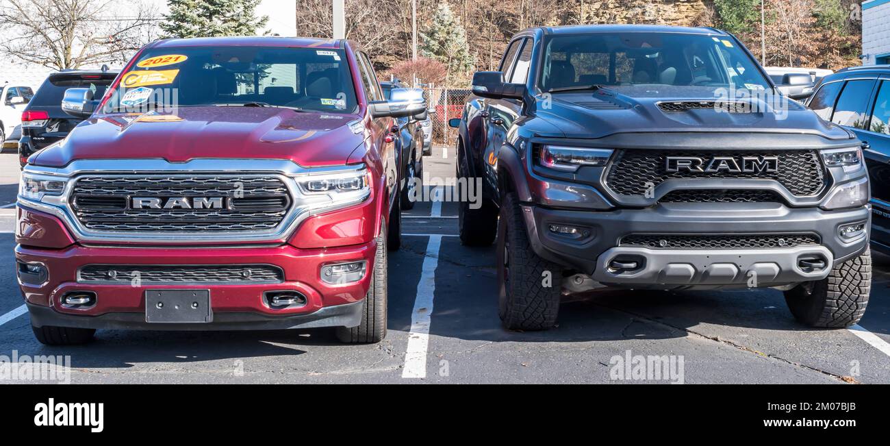 Two Ram trucks, one red and the other black for sale at a dealership in ...