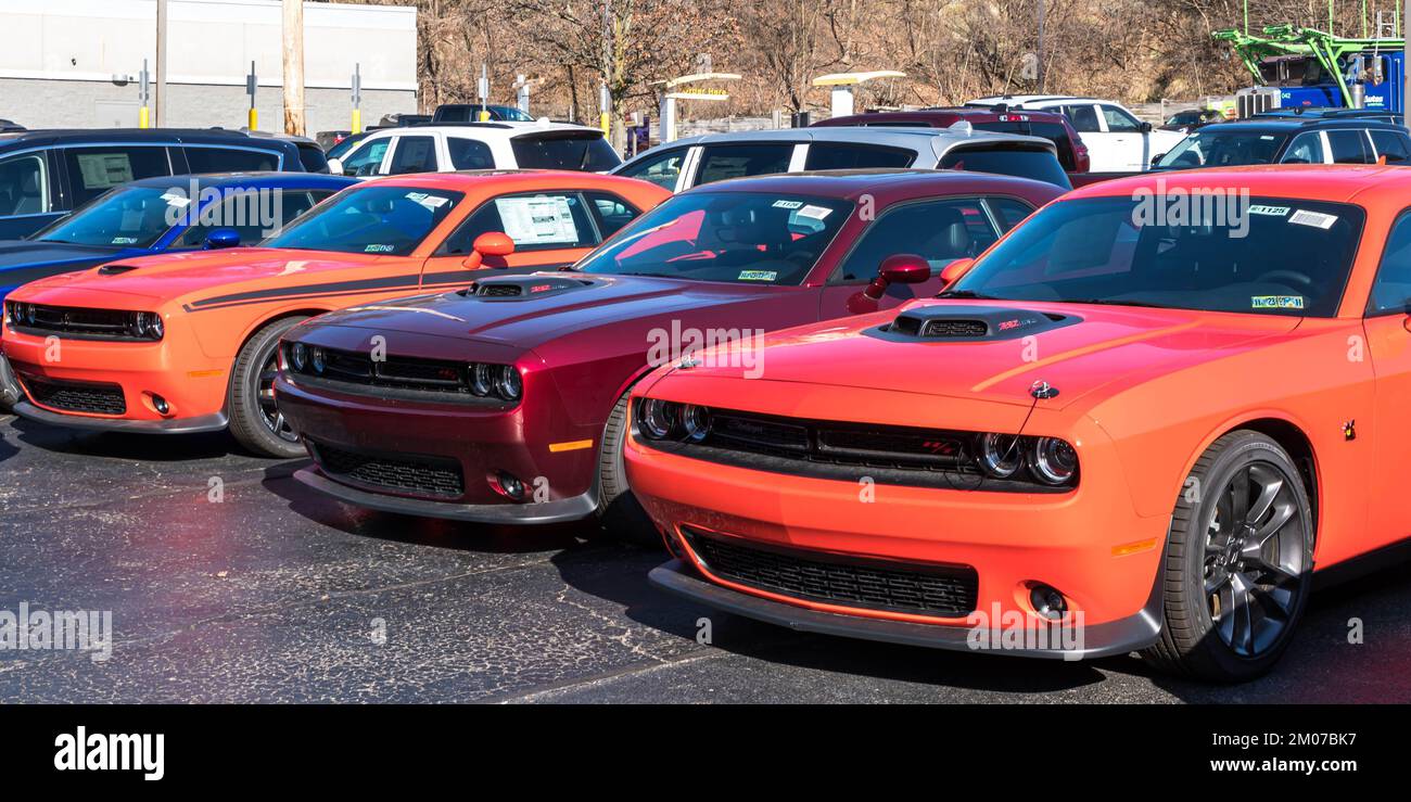 Three new Dodge Challenger coups lined up for sale at a dealership in ...