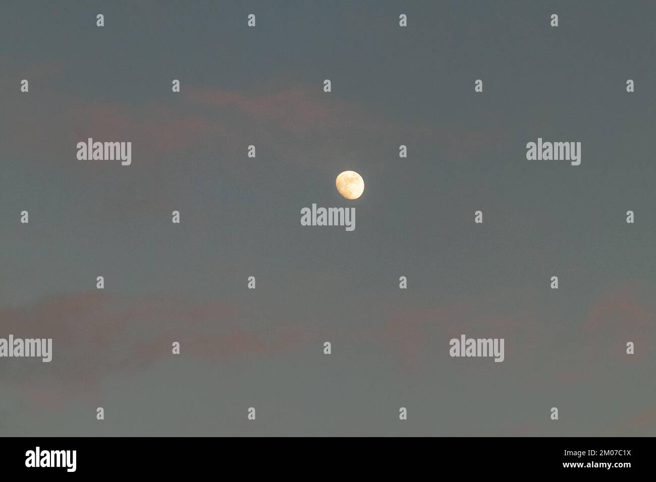 San Diego, CA. 4th Dec, 2022. The moon and pink sunset with clouds in ...