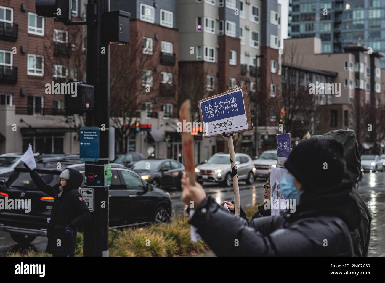 Bellevue, United States. 04th Dec, 2022. A protester holds up a "Urumqi ...