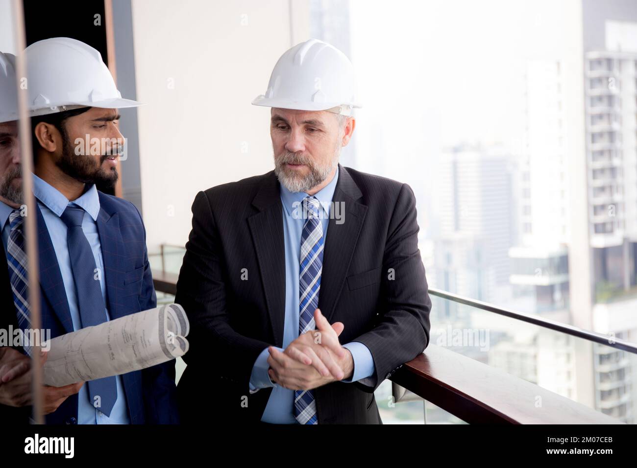 Senior architect inspector talking with contractor man together at ...