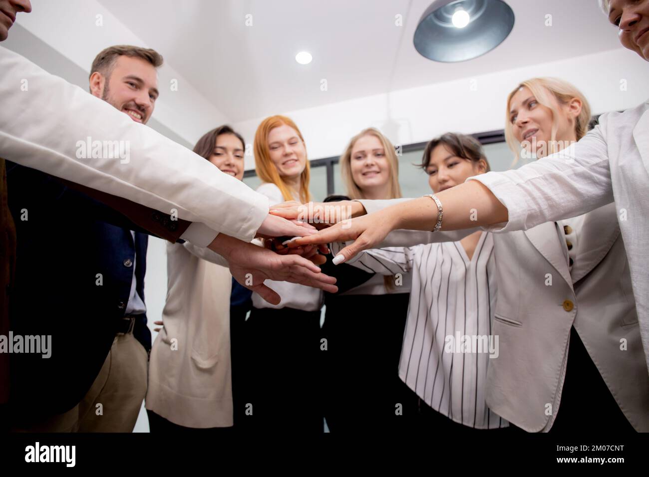 Group of business team harmonious with man and woman joining hands ...