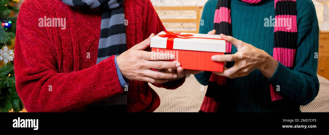 Young man giving presents for surprise girlfriend in celebration ...