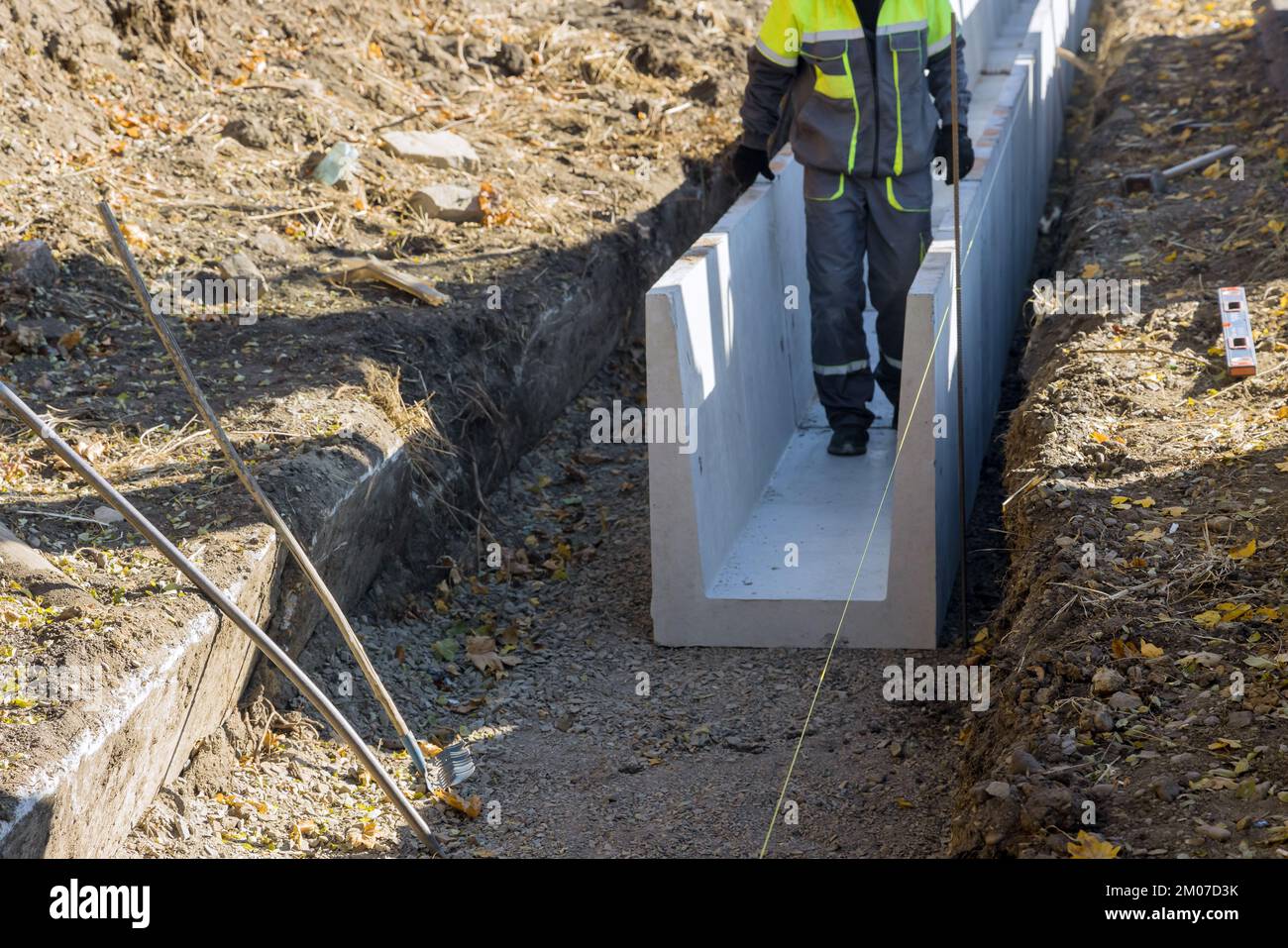 Installation of precast concrete u-shaped drains on reconstruction road ...