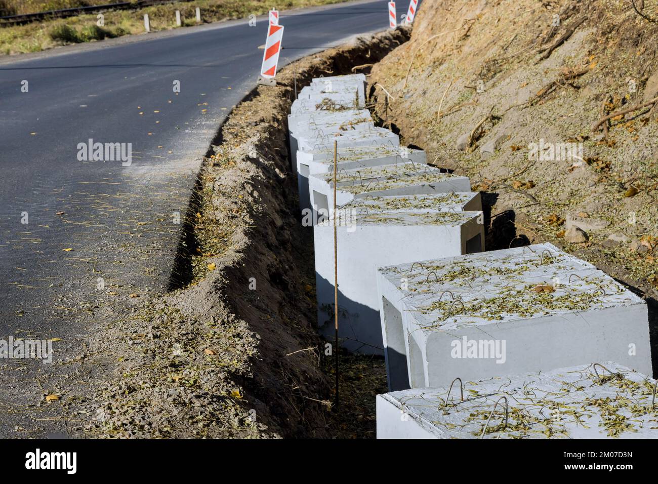 Installing precast u-shape concrete drains along reconstruction road ...