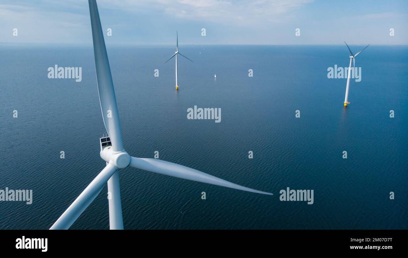 Windmill turbines at sea view from a drone aerial view from above at a ...
