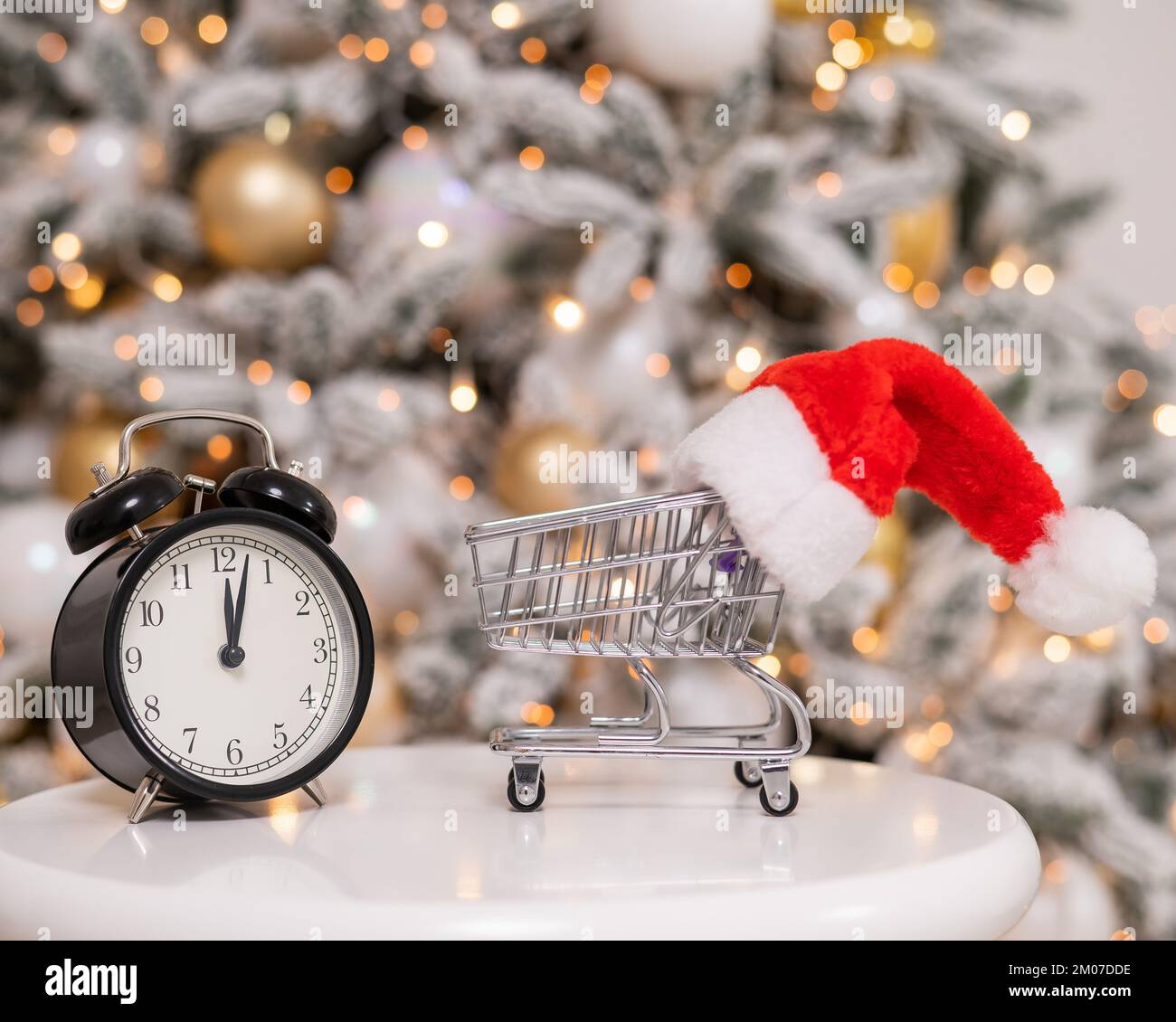 Christmas gifts shopping time. A shopping trolley with a santa hat and ...