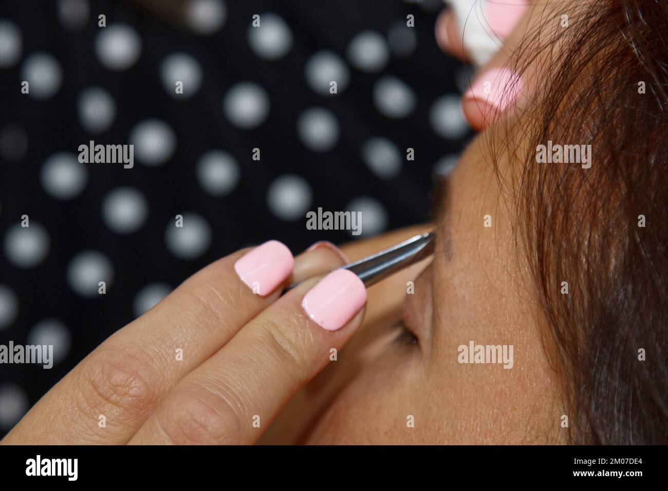 The master adjusts the makeup, and gives the form to pull out with ...