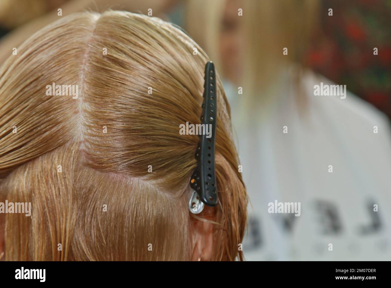 Woman with medium long blonde hair. With a short haircut at the ...