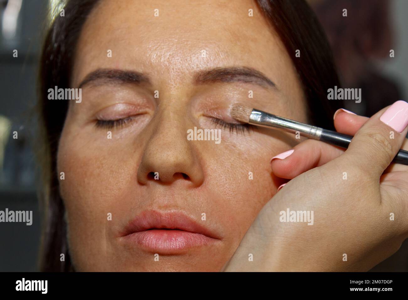Makeup Artist Applies Eye Shadow Beautiful Woman Face Hand Of